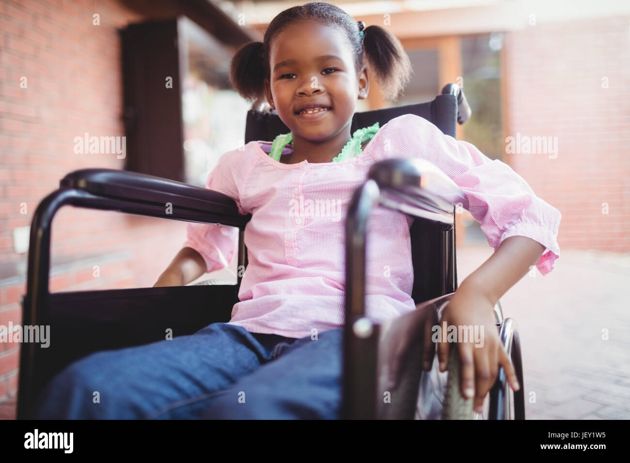 Girl siting in a wheelchair Stock Photo - Alamy