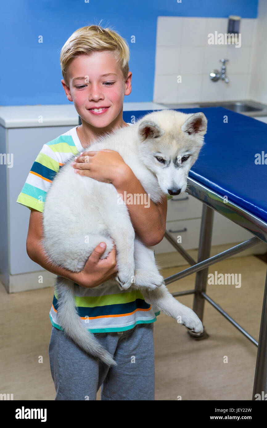 A little boy bringing a dog Stock Photo - Alamy