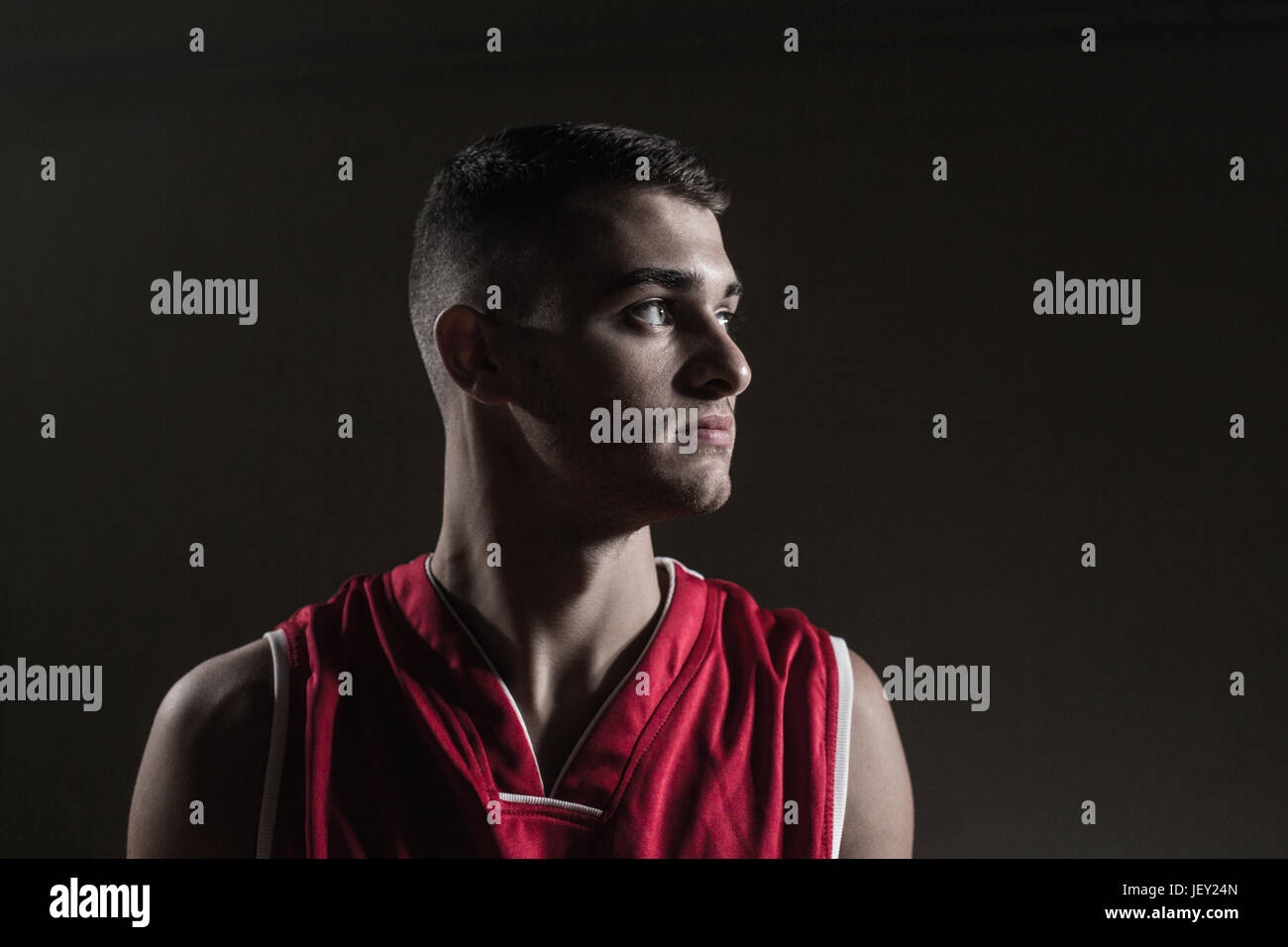 Basketball player looking away Stock Photo - Alamy