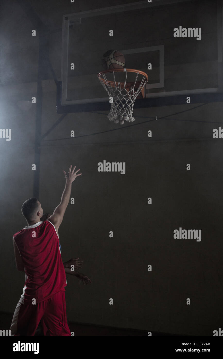 Portrait of basketball player scoring a goal Stock Photo - Alamy
