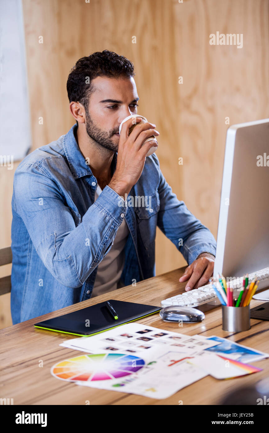 An attractive man working at computer desk Stock Photo - Alamy