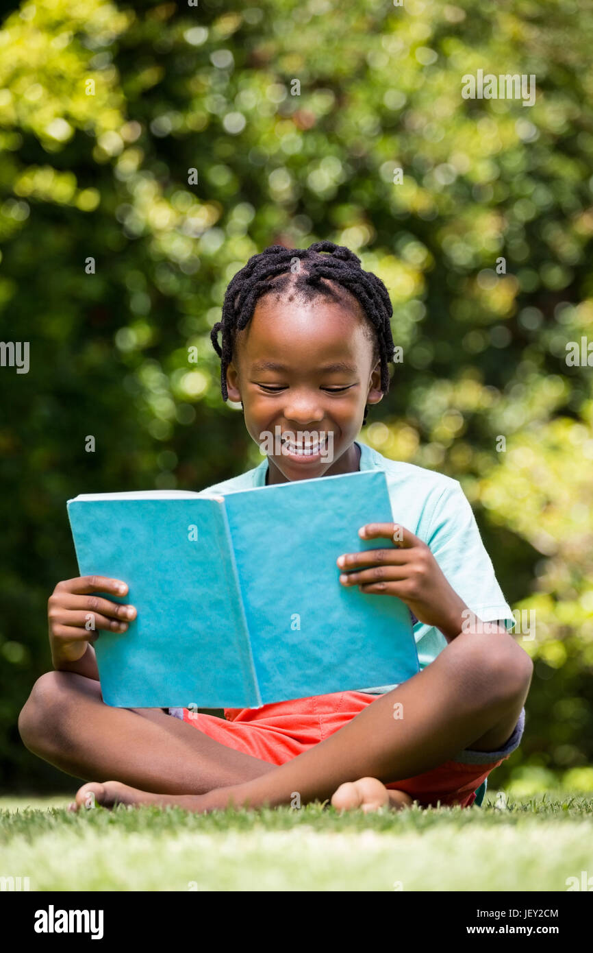 Boy is reading a book Stock Photo - Alamy