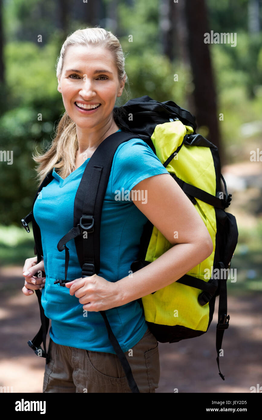Woman smiling and posing with a backpack Stock Photo - Alamy