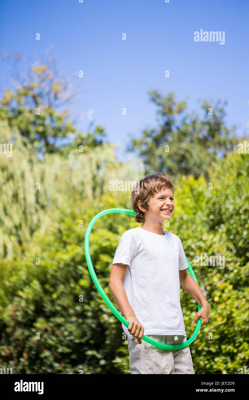 Smiling child playing with a hoop Stock Photo - Alamy