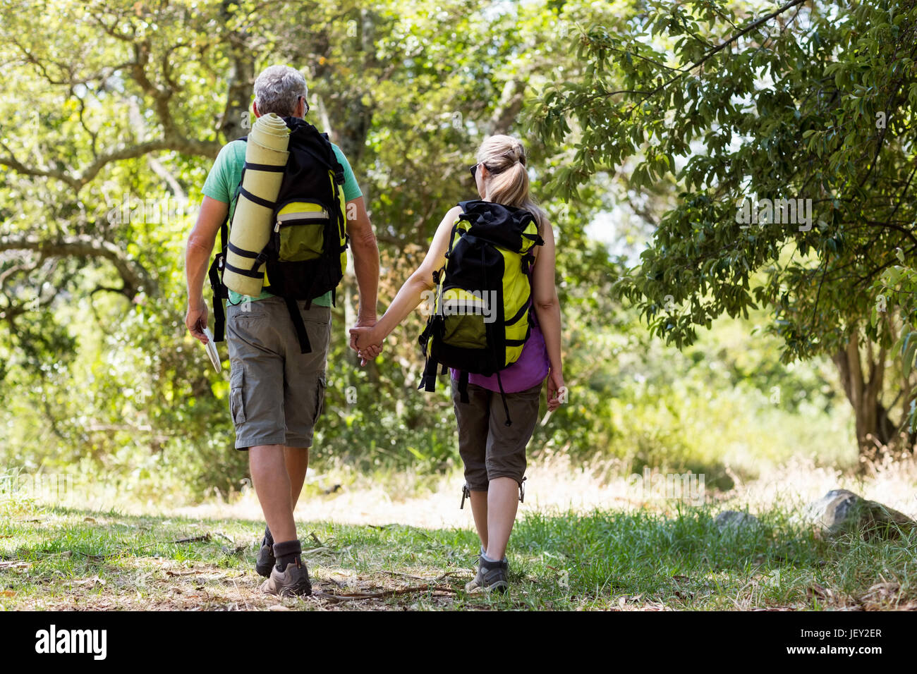 Couple hiking and holding hands each other Stock Photo - Alamy