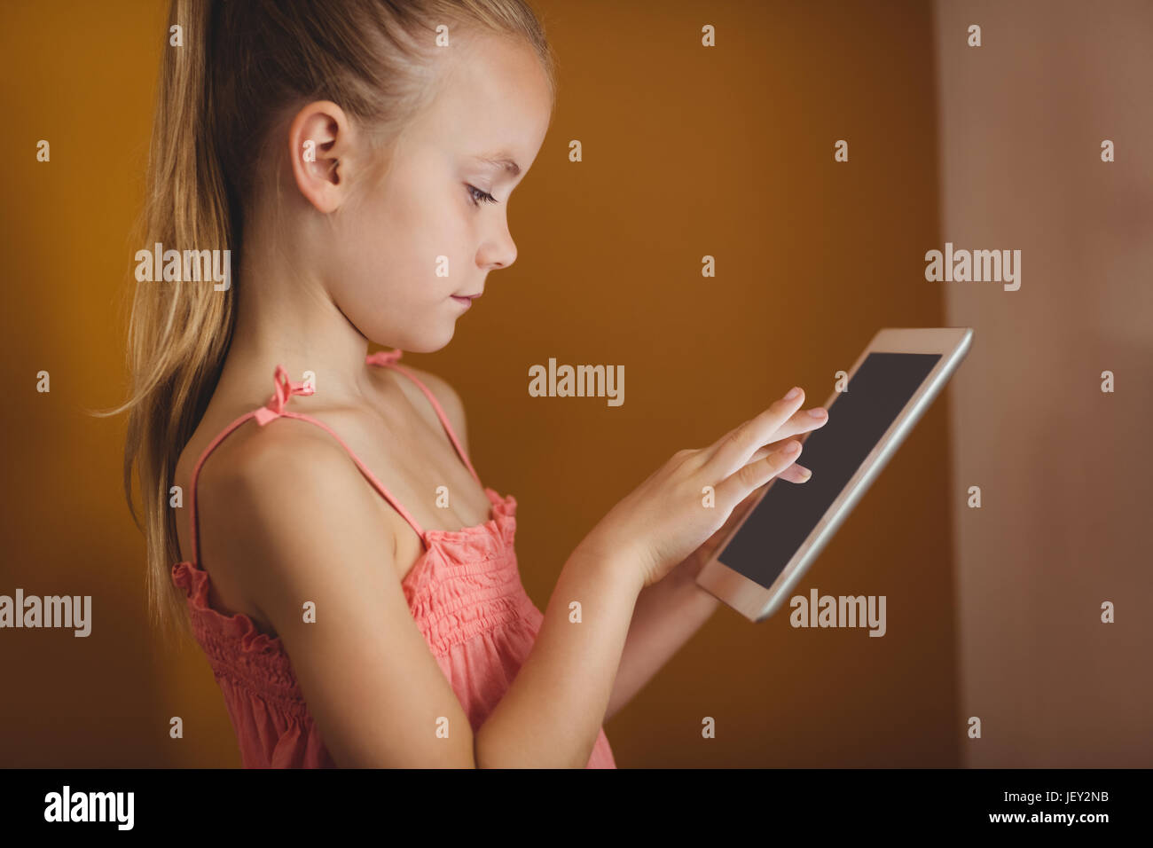 Little girl using a tablet Stock Photo - Alamy