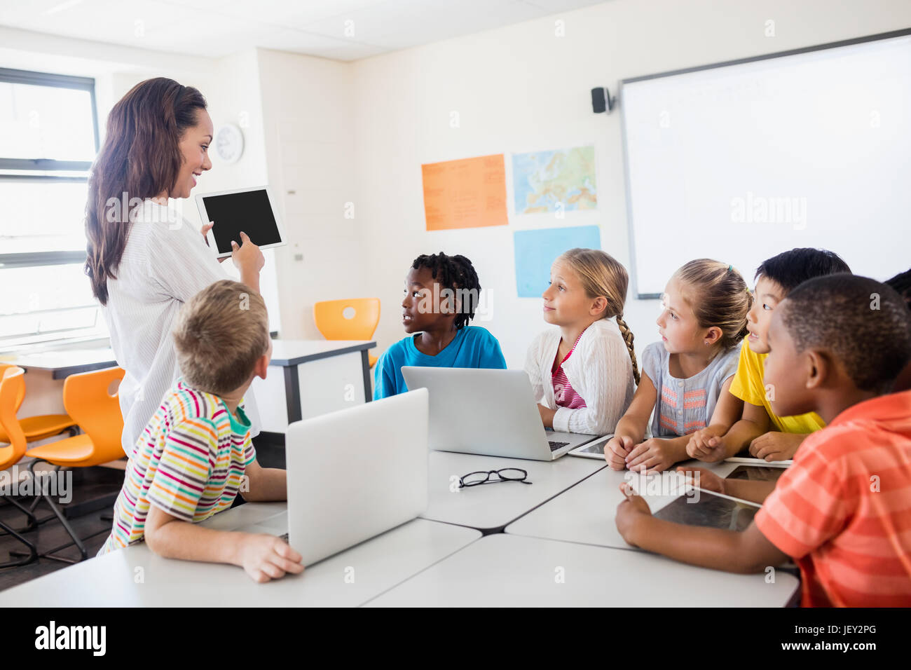 A teacher giving lesson with technology Stock Photo - Alamy