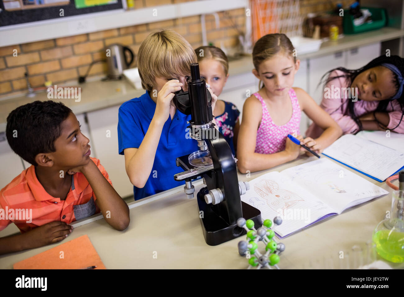 Cute school girl microscope in hi-res stock photography and images - Alamy