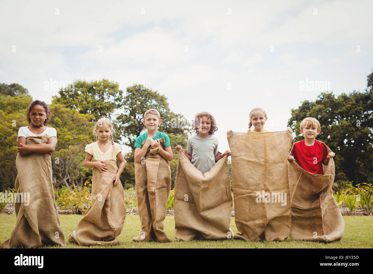 Children smiling and posing inside bag Stock Photo - Alamy