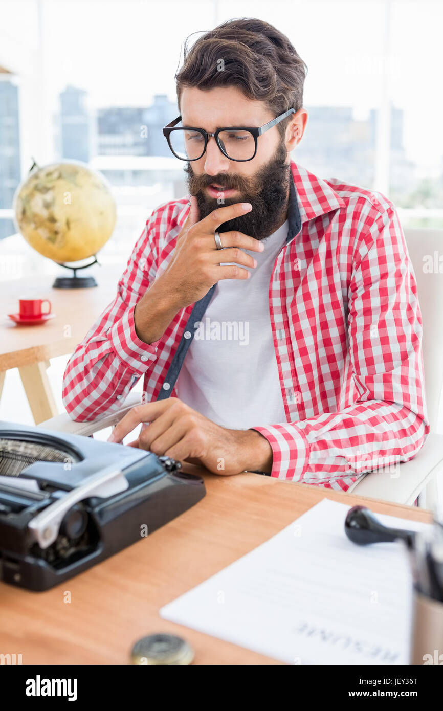 Hipster man using a typewriter Stock Photo - Alamy