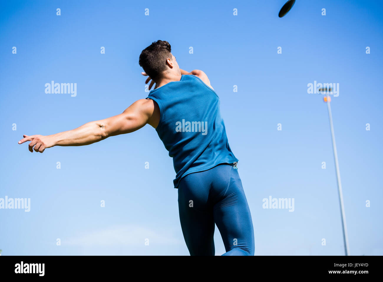 Athlete throwing discus in stadium Stock Photo - Alamy