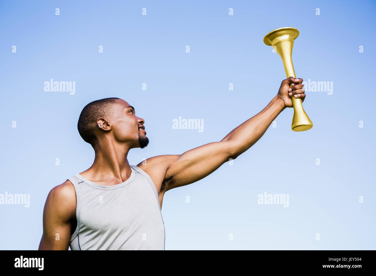 Athlete holding a fire torch Stock Photo - Alamy