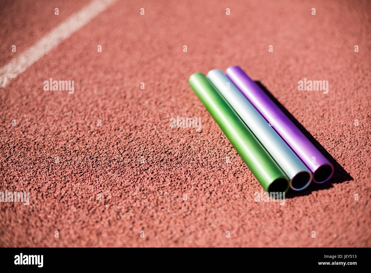 Relay baton on running track Stock Photo - Alamy