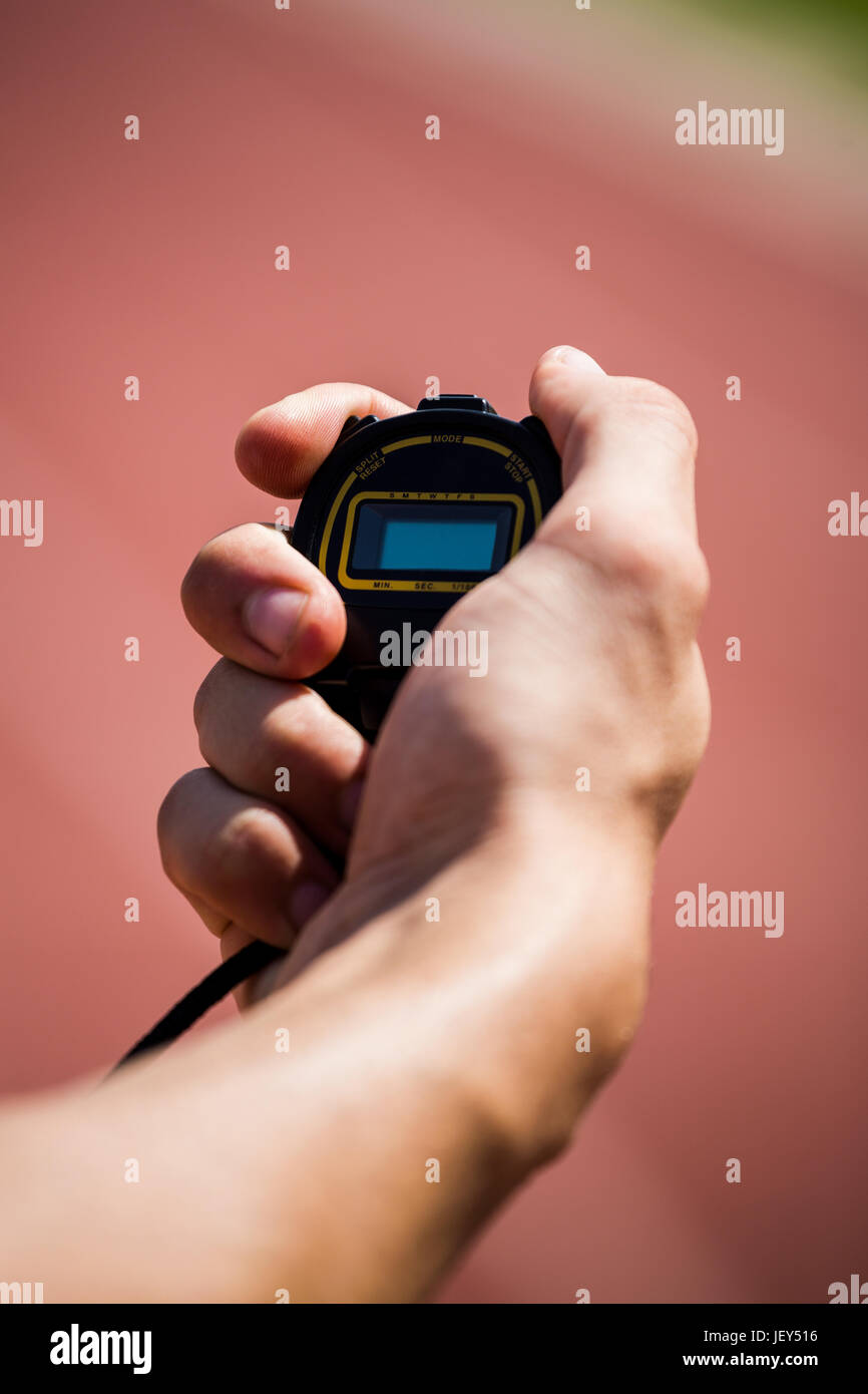Hand holding a stopwatch Stock Photo - Alamy