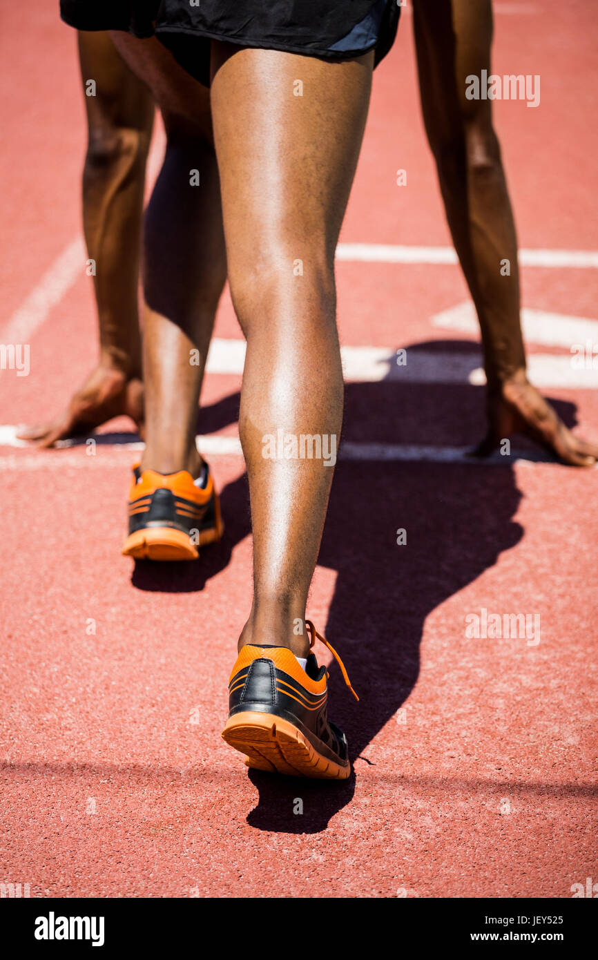 Athlete on a starting line about to run Stock Photo - Alamy