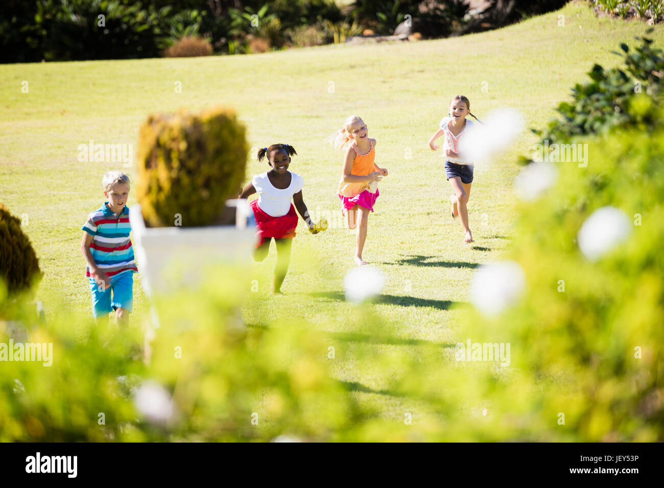 Kids playing together during a sunny day Stock Photo - Alamy