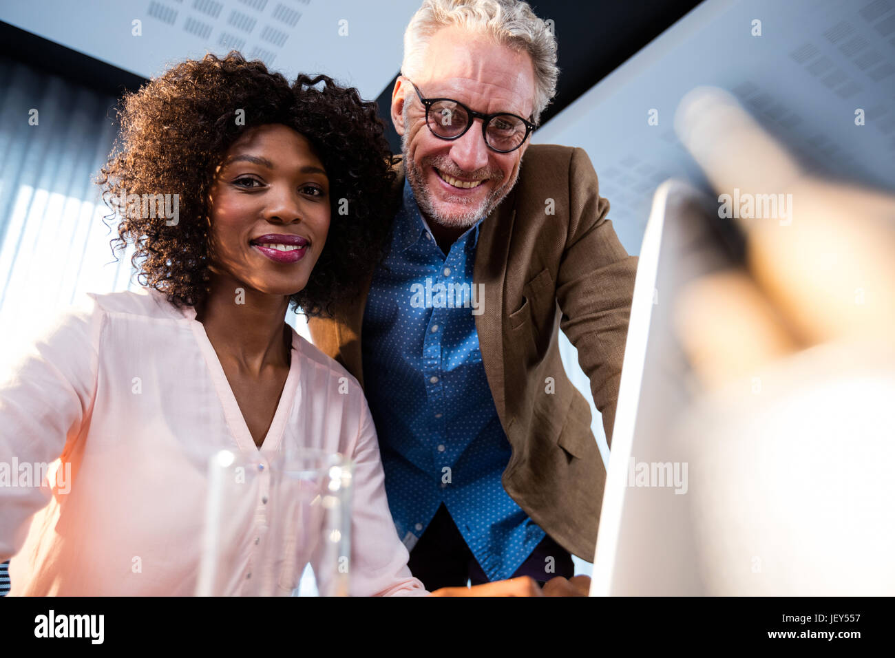 Two businessmen working on a computer Stock Photo - Alamy
