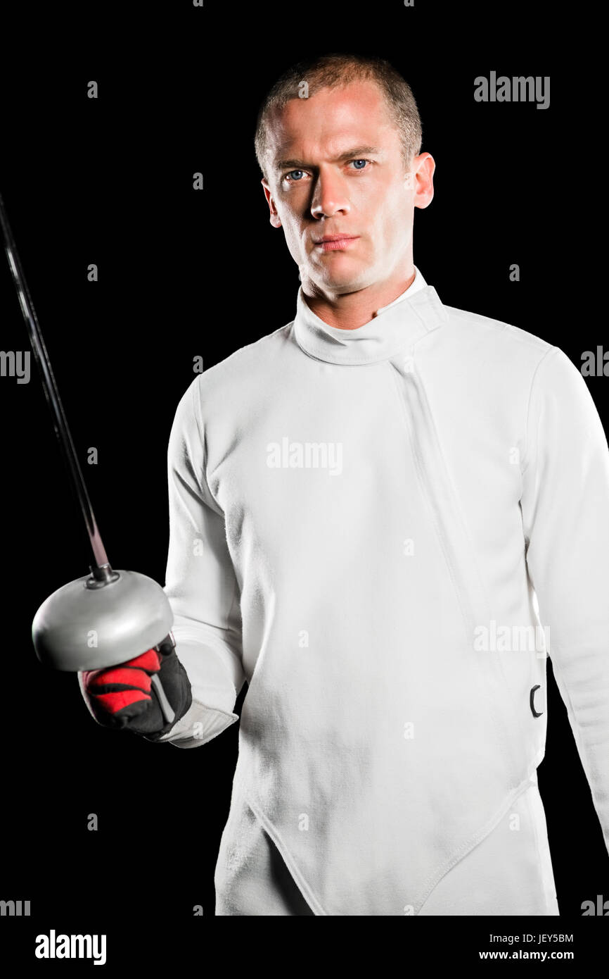 Swordsman holding fencing sword Stock Photo - Alamy