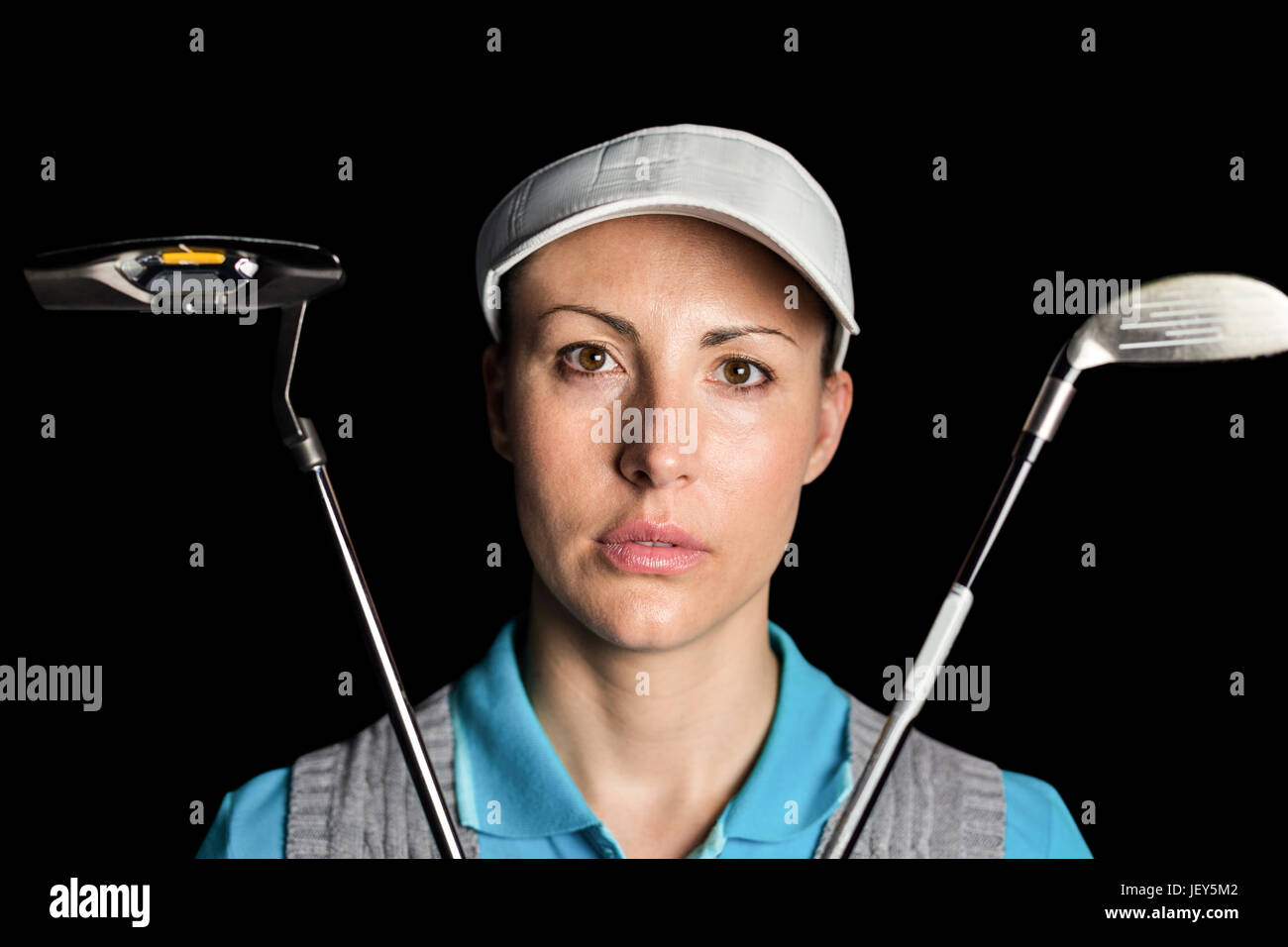 Golf player posing with golf club Stock Photo - Alamy