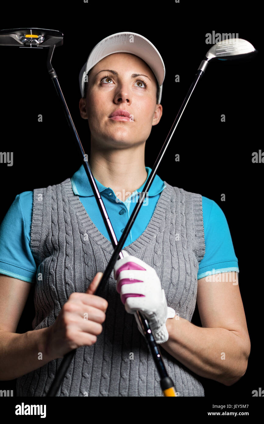 Golf player posing with golf club Stock Photo - Alamy