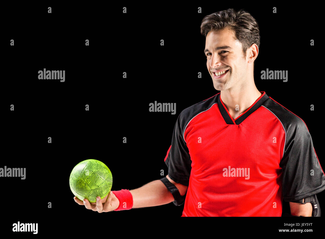 Happy athlete man holding a ball Stock Photo - Alamy