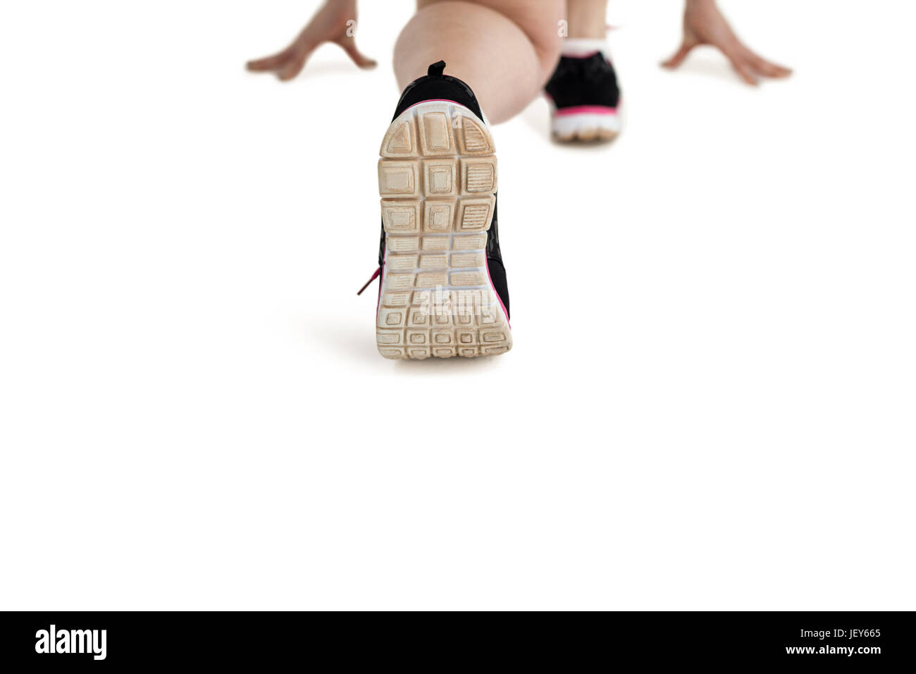 Athlete woman in ready to run position Stock Photo - Alamy