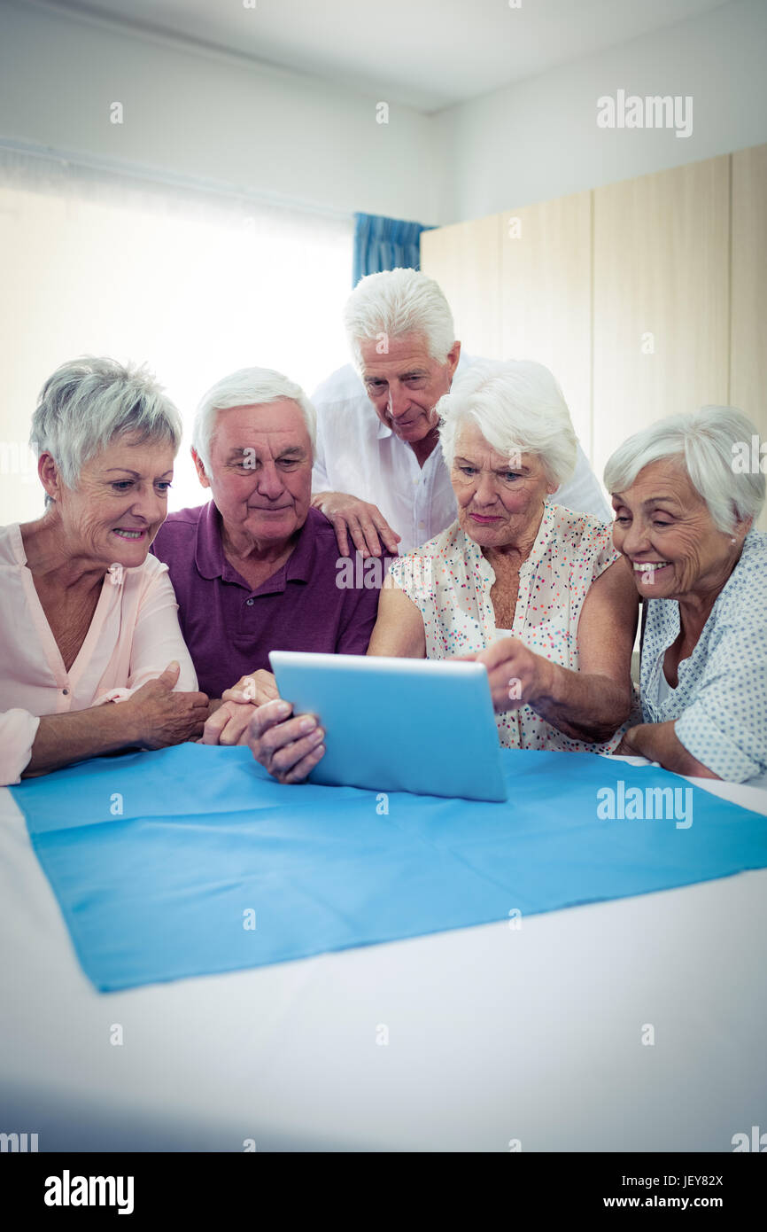 Group of seniors using a tablet computer Stock Photo - Alamy