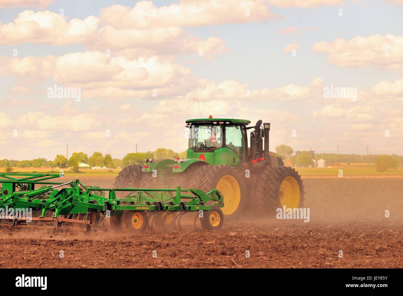 Farmer Using Tractor To Till And Prepare His Field For Crops On A Farm