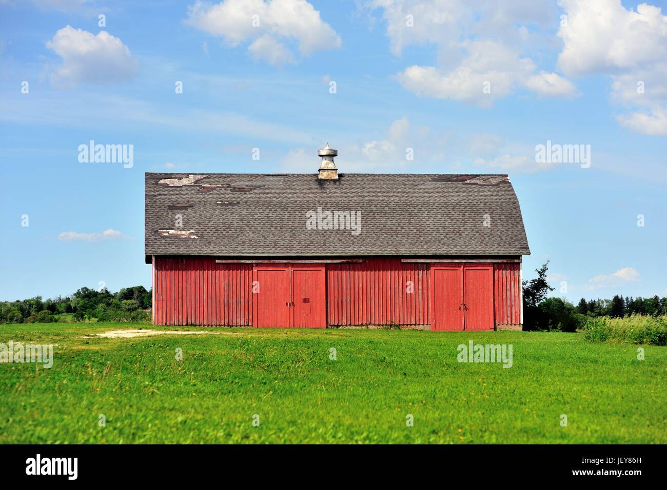 Venerable barn with side door access to storage in the middle of farm ...