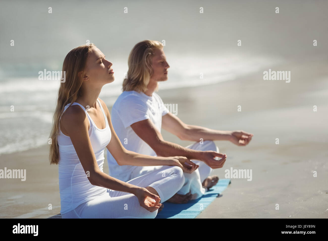 Man and woman performing yoga Stock Photo - Alamy