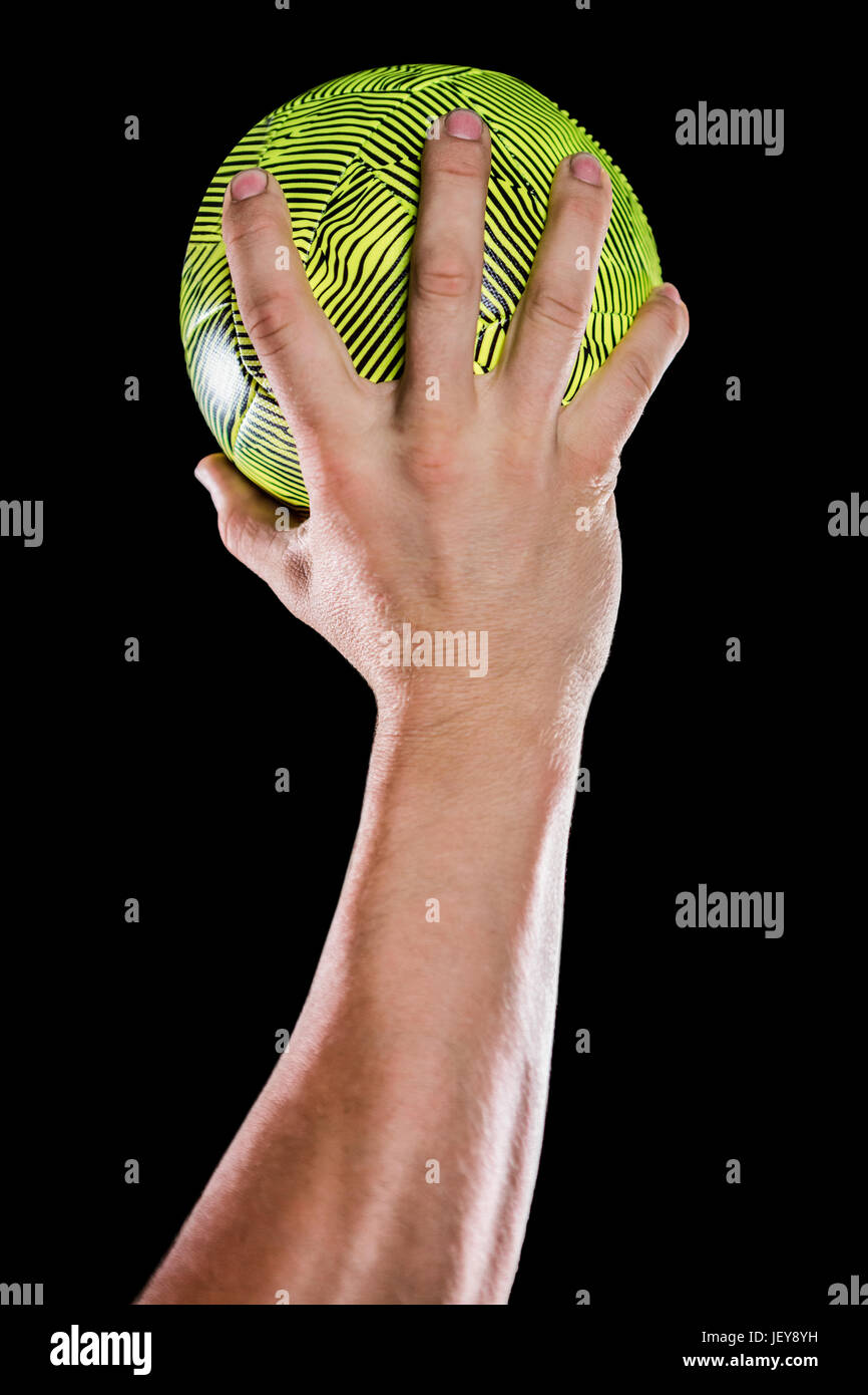 Sportsman holding a ball Stock Photo - Alamy