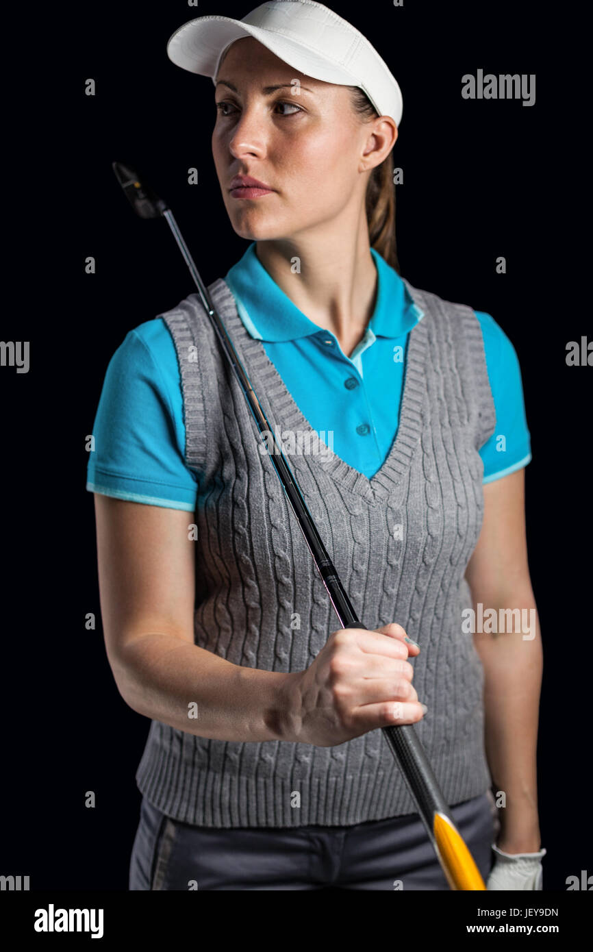 Golf player posing with golf club Stock Photo - Alamy