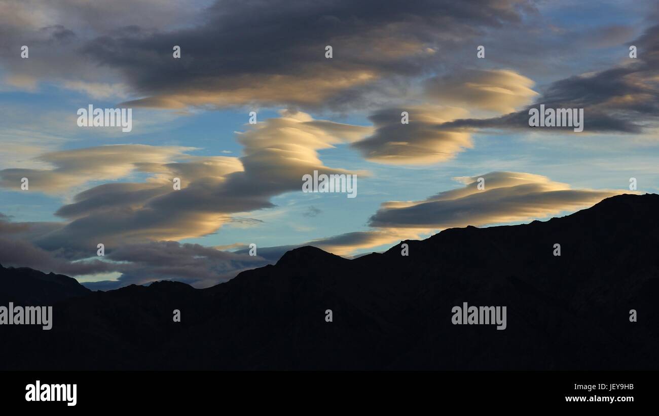 Unique shaped clouds at sunrise Stock Photo - Alamy