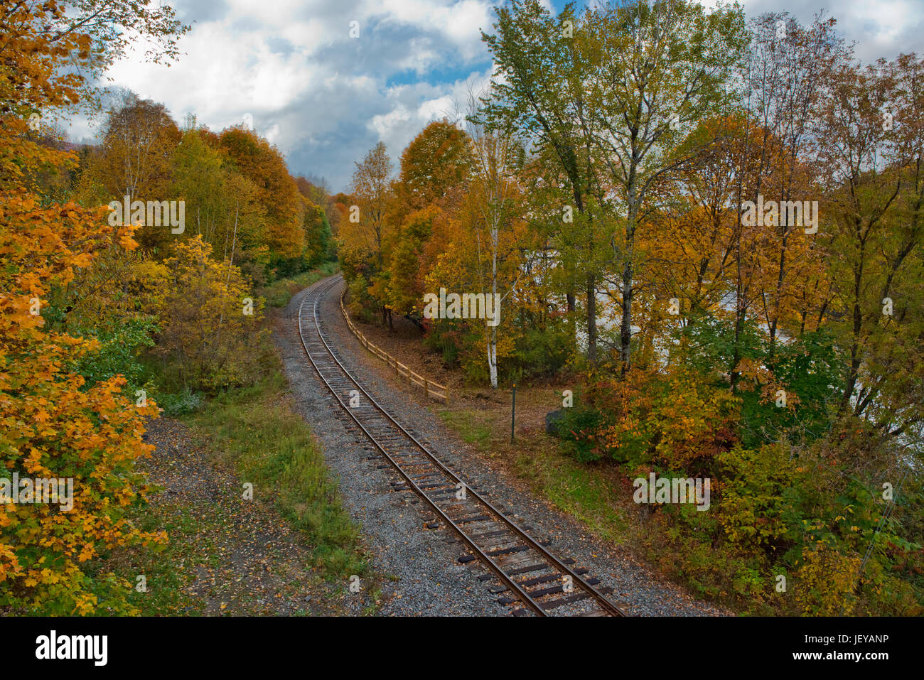 Train tracks by the river in peak fall foliage, Adirondacks, NY, United ...