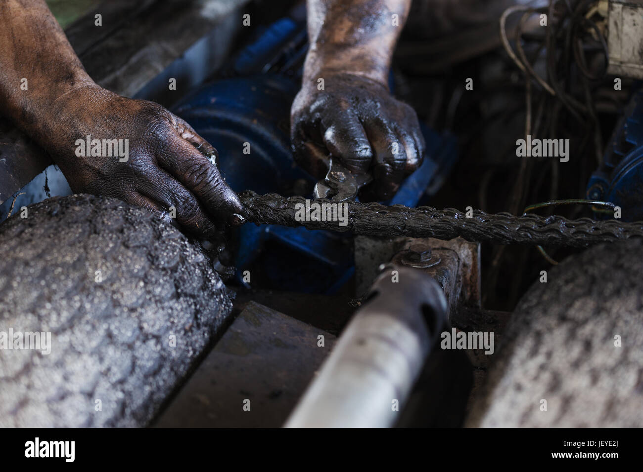 Hand of repairman during maintenance work of chain Stock Photo - Alamy