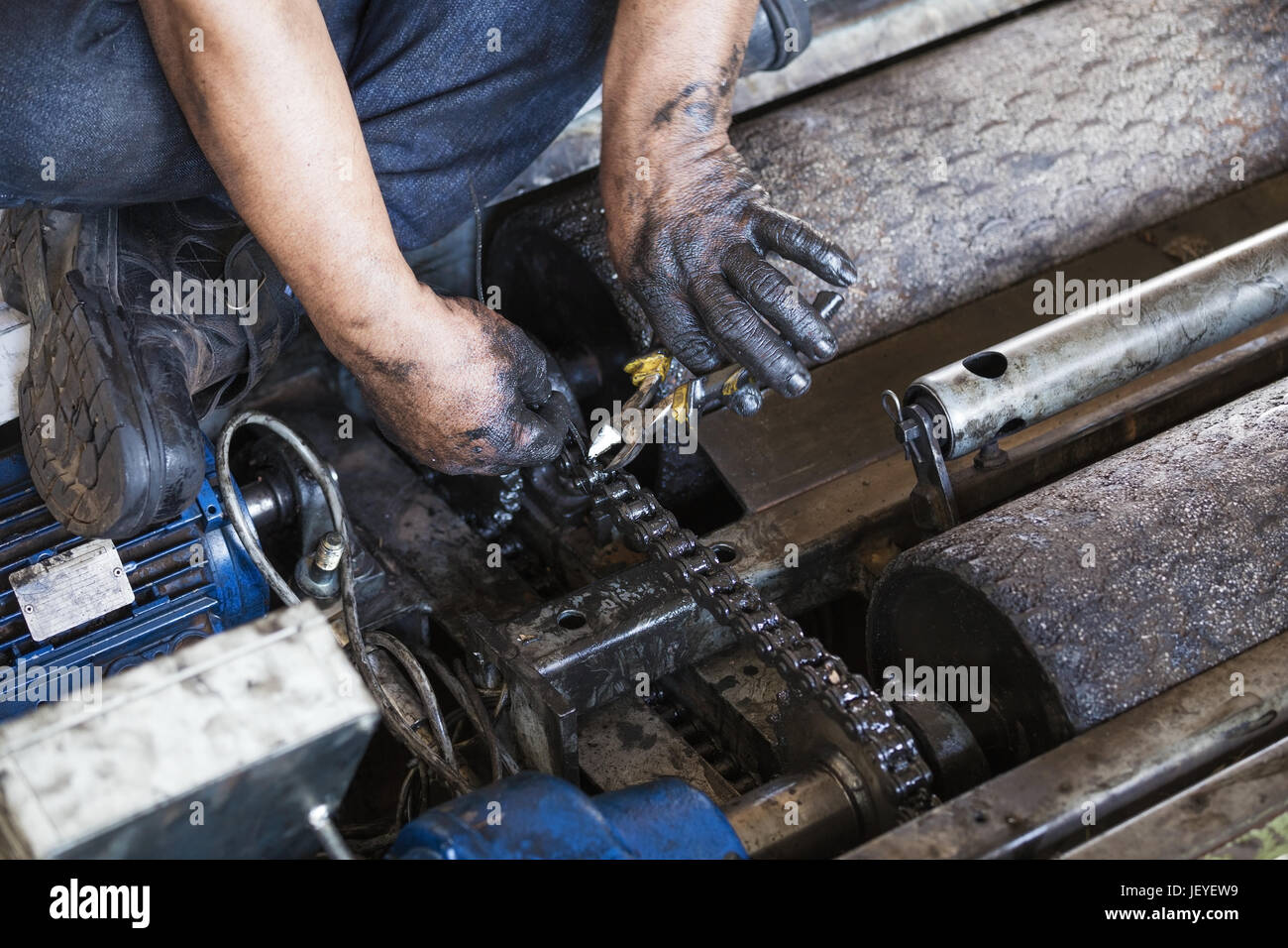 Hand of repairman during maintenance work of chain Stock Photo - Alamy