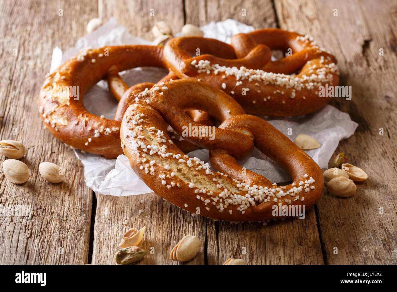 Traditional pretzel with salt and pistachio close-up on the table ...