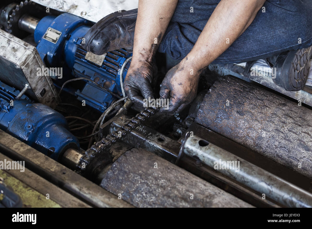 Hand of repairman during maintenance work of chain Stock Photo - Alamy