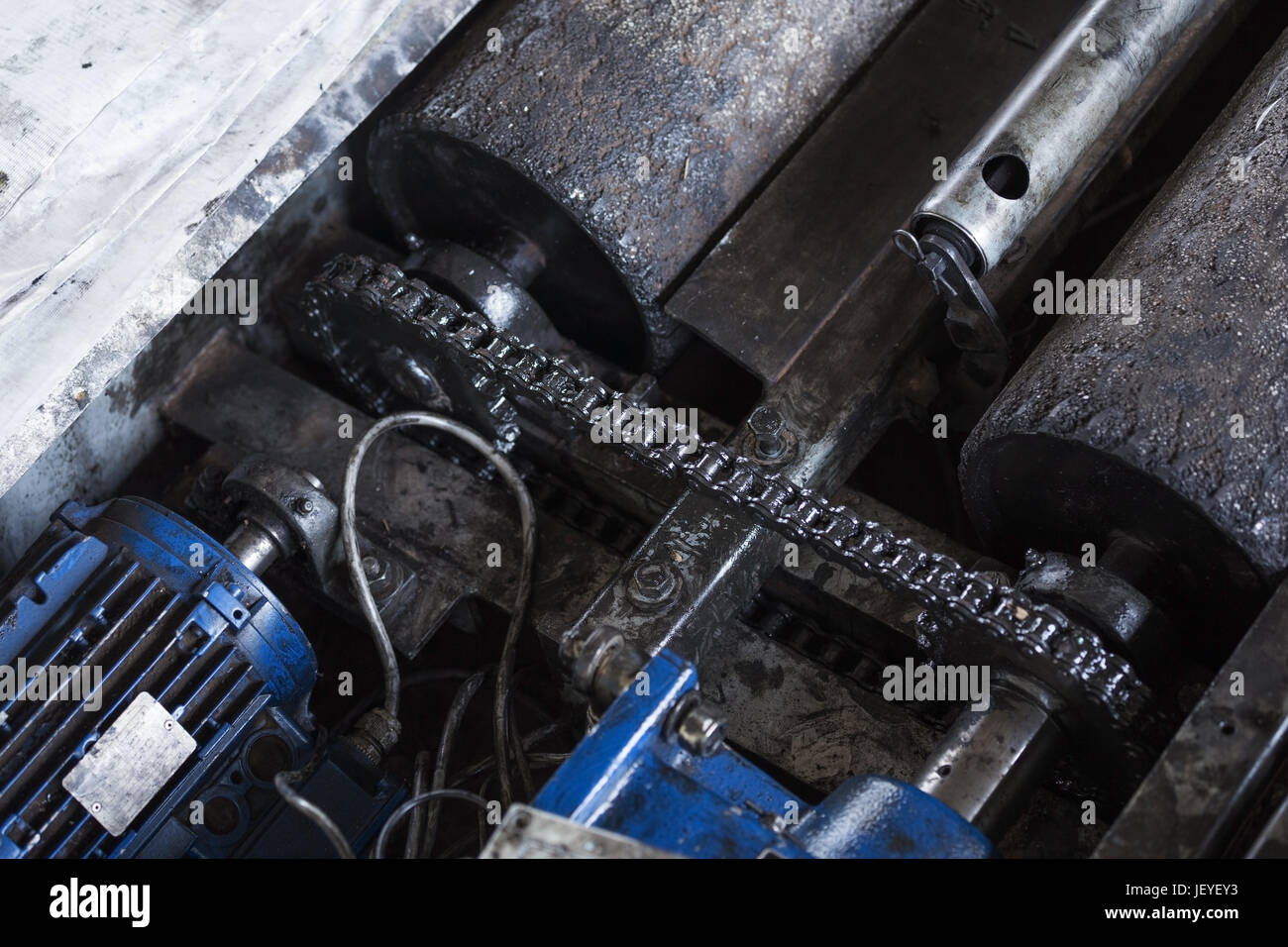 chain with electric motor and roller of machine Stock Photo - Alamy