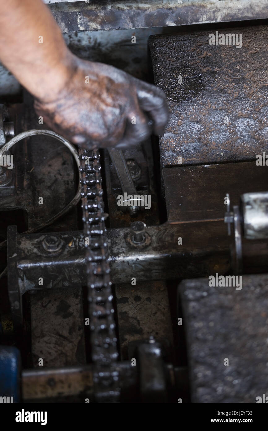 Hand of repairman holding a wrench and tighten and during maintenance ...