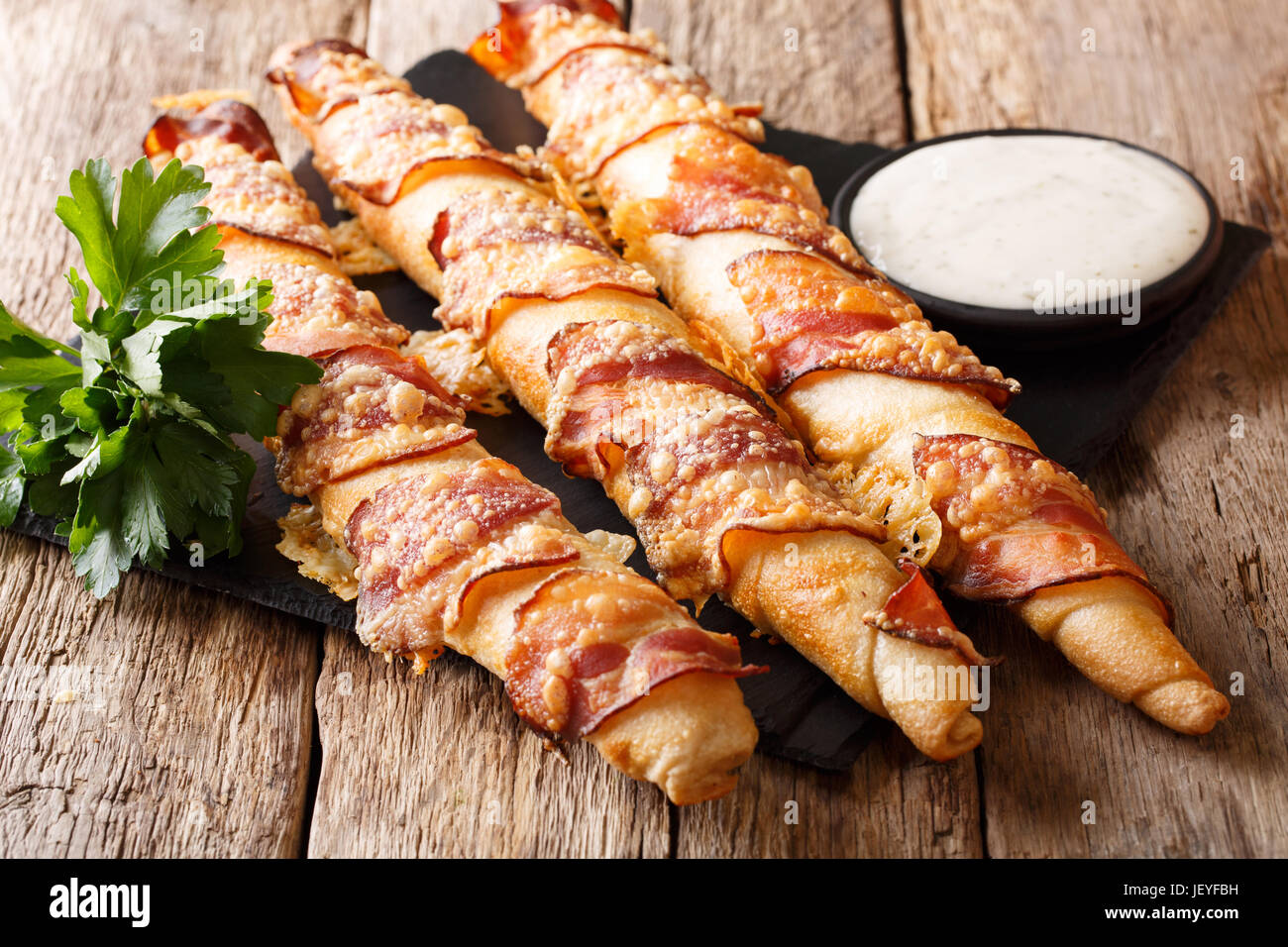German sticks with bacon and cheese close-up on the table and garlic ...