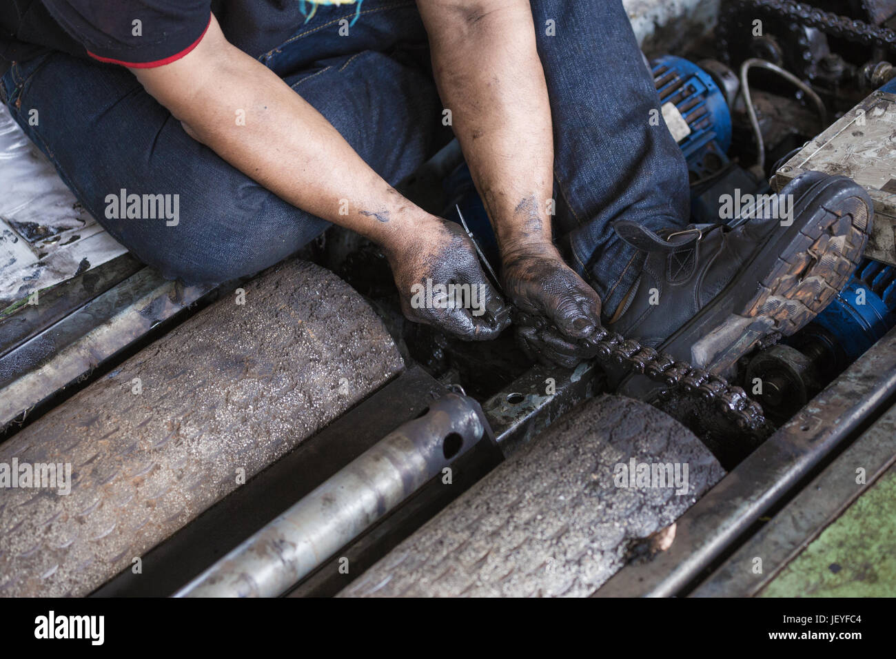 Hand of repairman during maintenance work of chain Stock Photo - Alamy