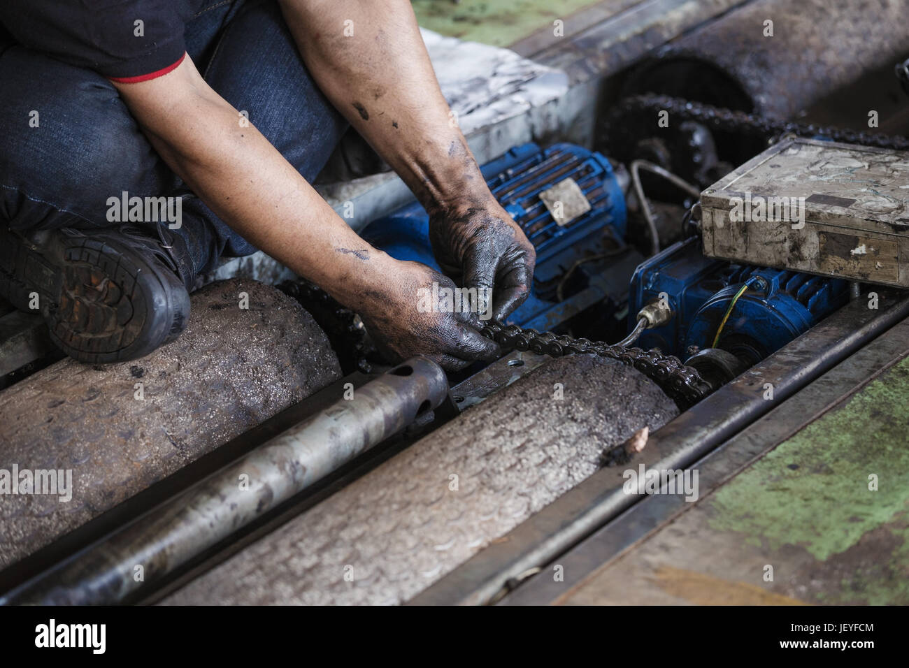 Hand of repairman during maintenance work of chain Stock Photo - Alamy