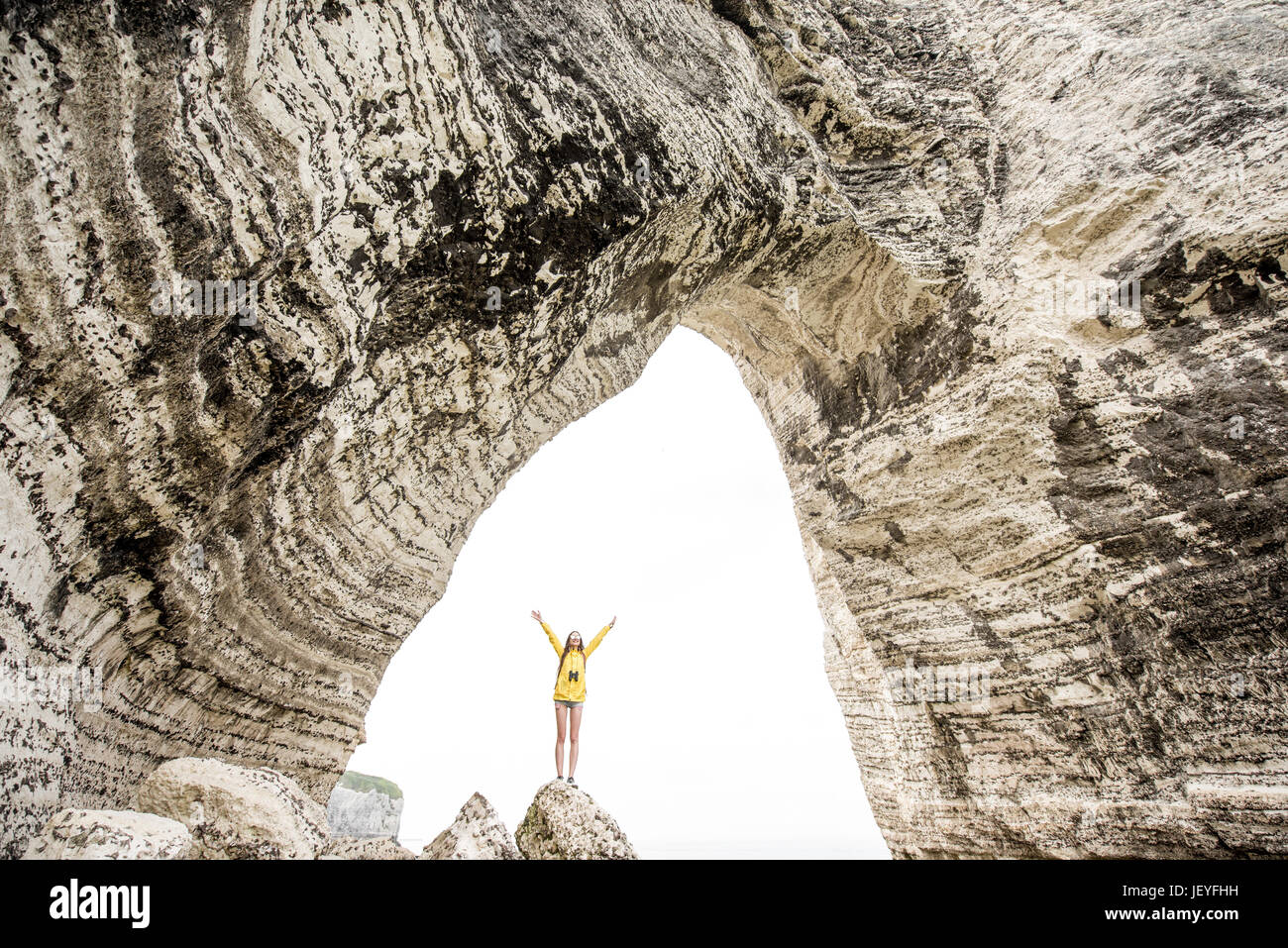 Landscape view on the huge stone cliff with a hole and traveler ...