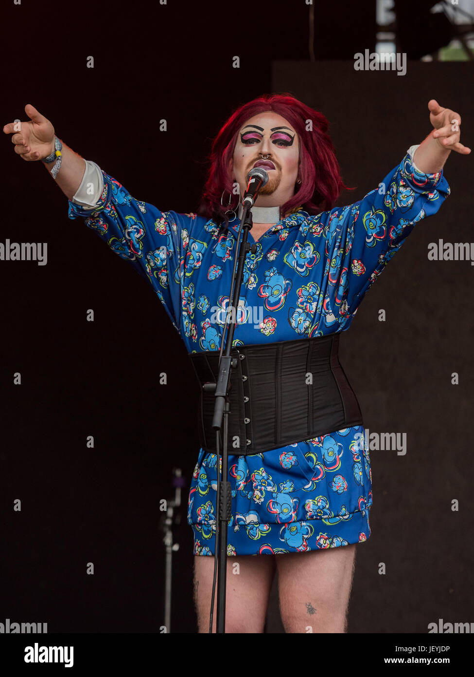 Denim, a drag band, perform on the Greenpeace Stage in front of dancing ...