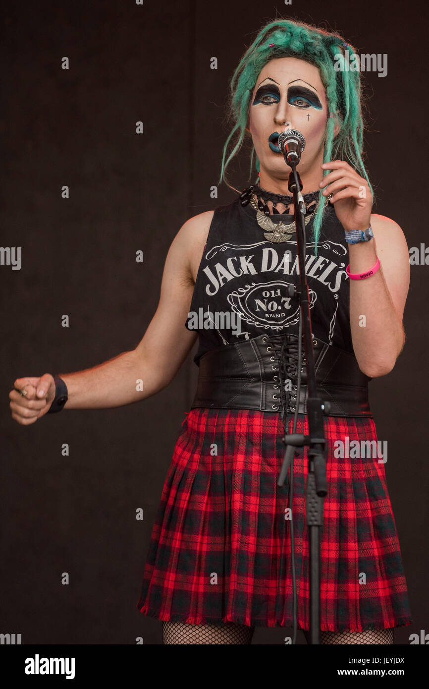 Denim, a drag band, perform on the Greenpeace Stage in front of dancing ...