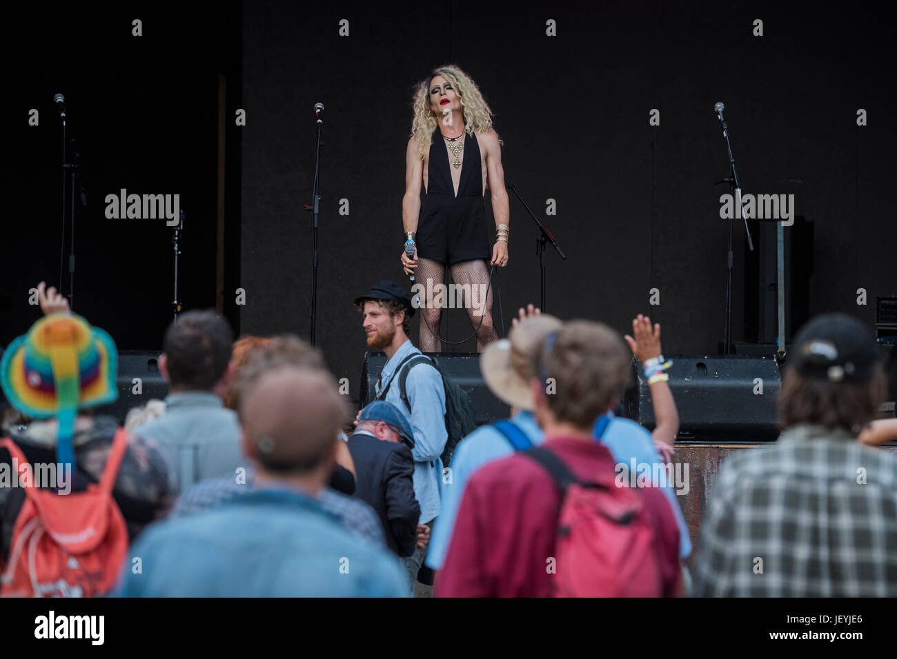 Denim, a drag band, perform on the Greenpeace Stage in front of dancing ...