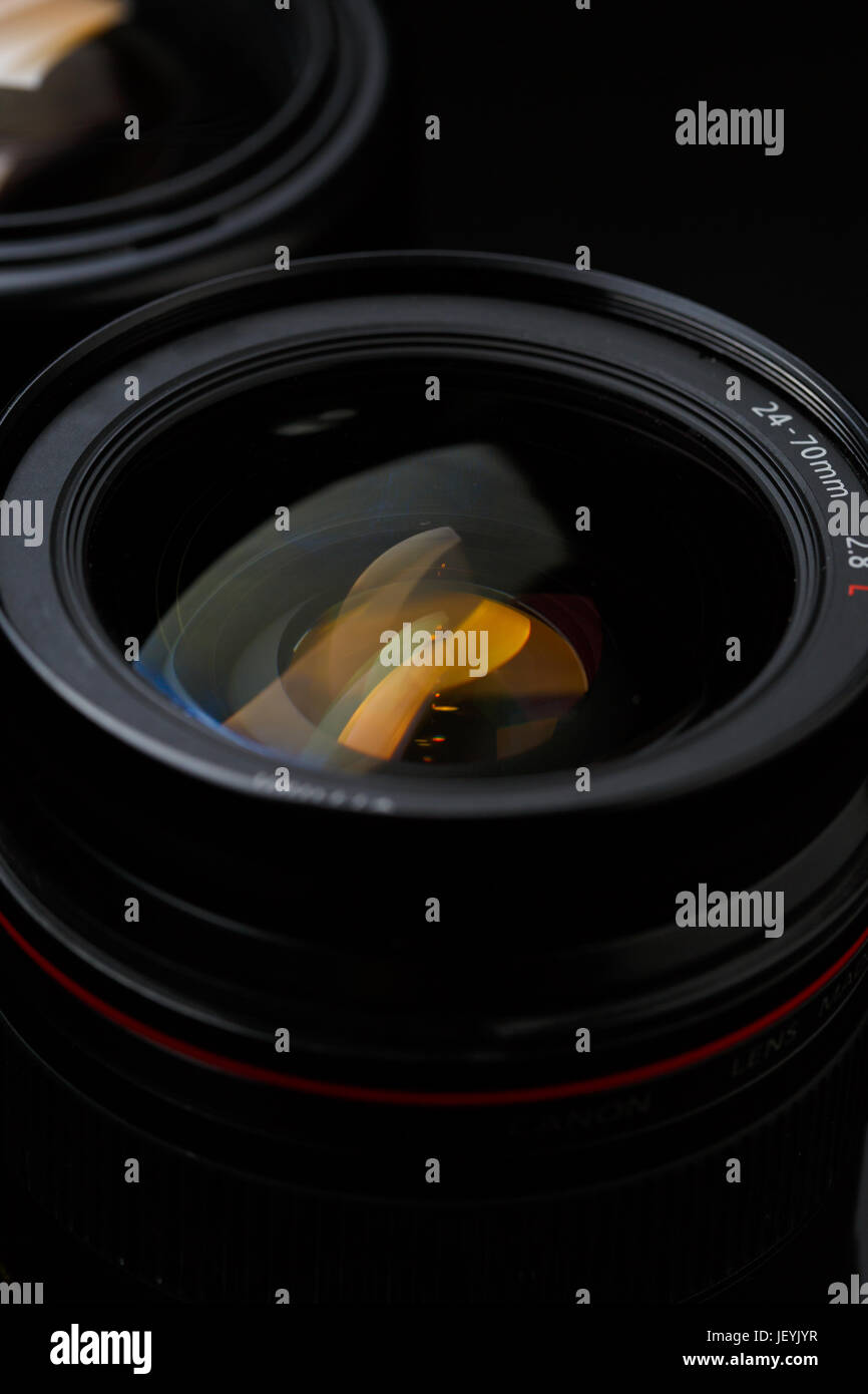 Two camera lenses on empty black background Stock Photo - Alamy
