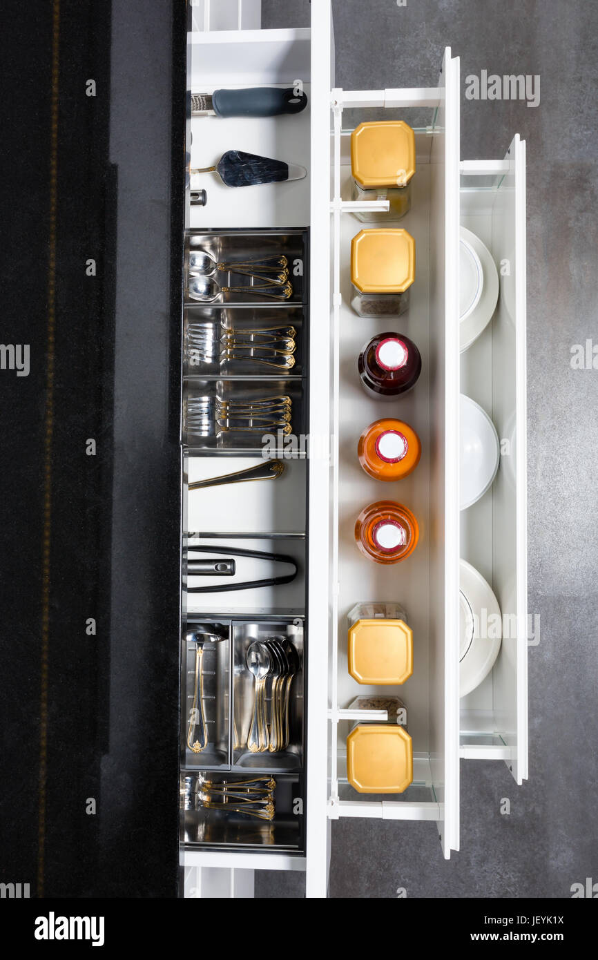 Modern kitchen countertop with food ingredients. Top view of drawers ...