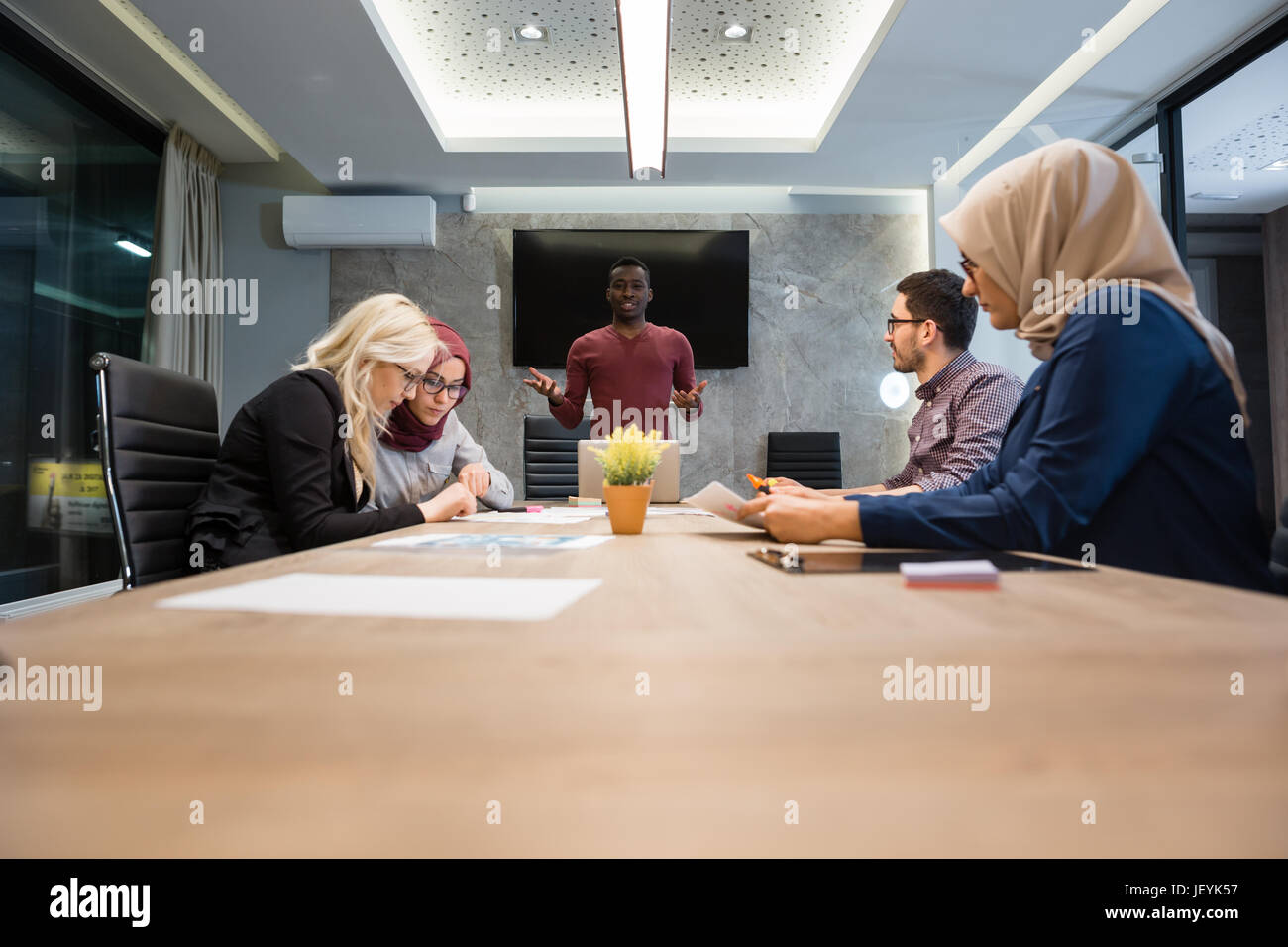 Multi-Cultural Office Staff Sitting Having Meeting Together Stock Photo ...